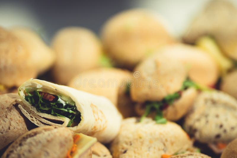 Sliced Wrap Food with Meat and Vegetables on a Stack of Sandwiches ...