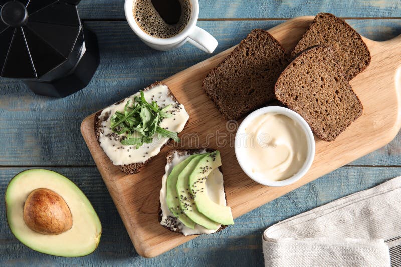 Slices of Bread with Toppings on Blue Wooden Table, Flat Lay Stock ...