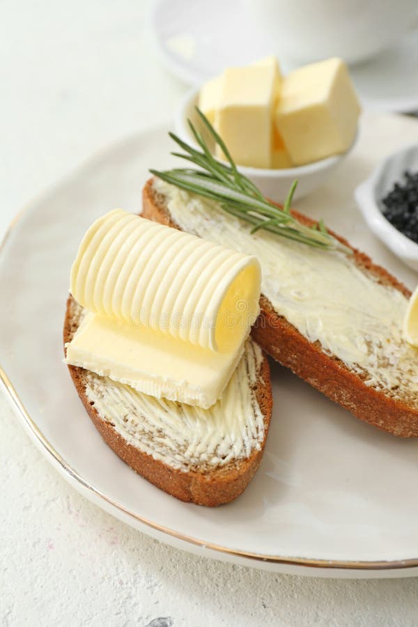 Slices of Bread with Fresh Butter on Plate, Closeup Stock Photo - Image ...