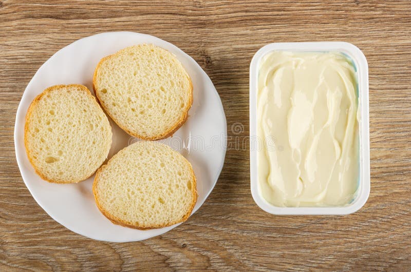 Slices of Bread in Plate, Box with Cream Cheese on Wooden Table. Top ...