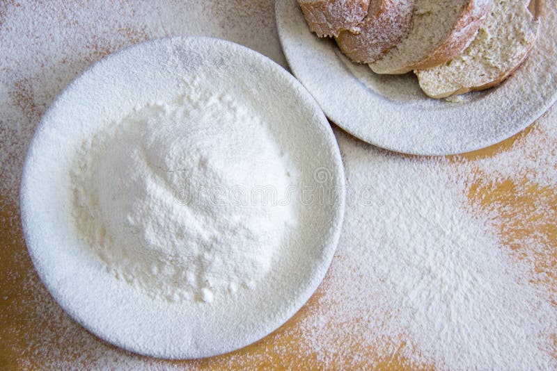 Slices of Bread and Wheat Flour in a White Plate on the Table Stock ...