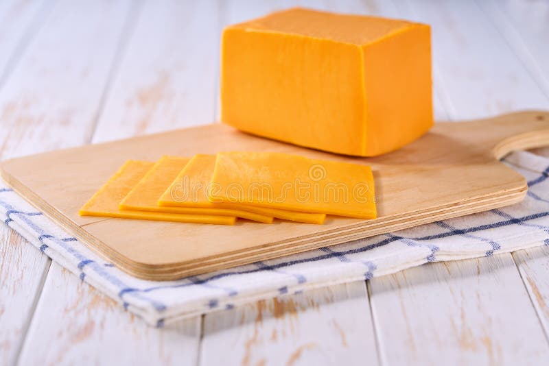 Slices of Cheddar Cheese on a Cutting Board, Selective Focus Stock ...