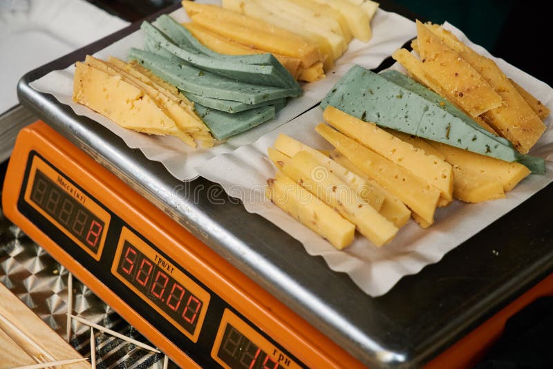 Sliced Cheese Slices Lie on a Plate on the Scales. Different Varieties ...