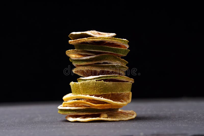Slices of Dried Lemons and Lime Stacked in a Column on a Dark ...