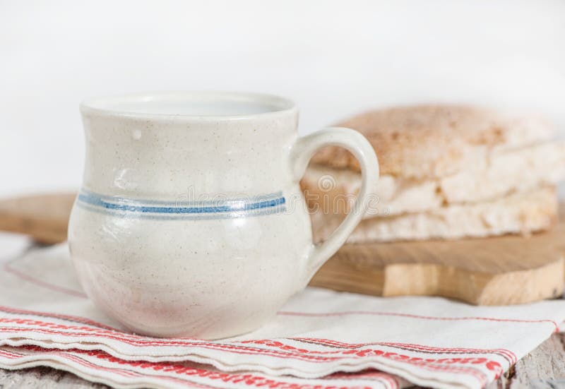Slices of Fresh Bread and Cup of Milk on the Old Table Stock Image ...