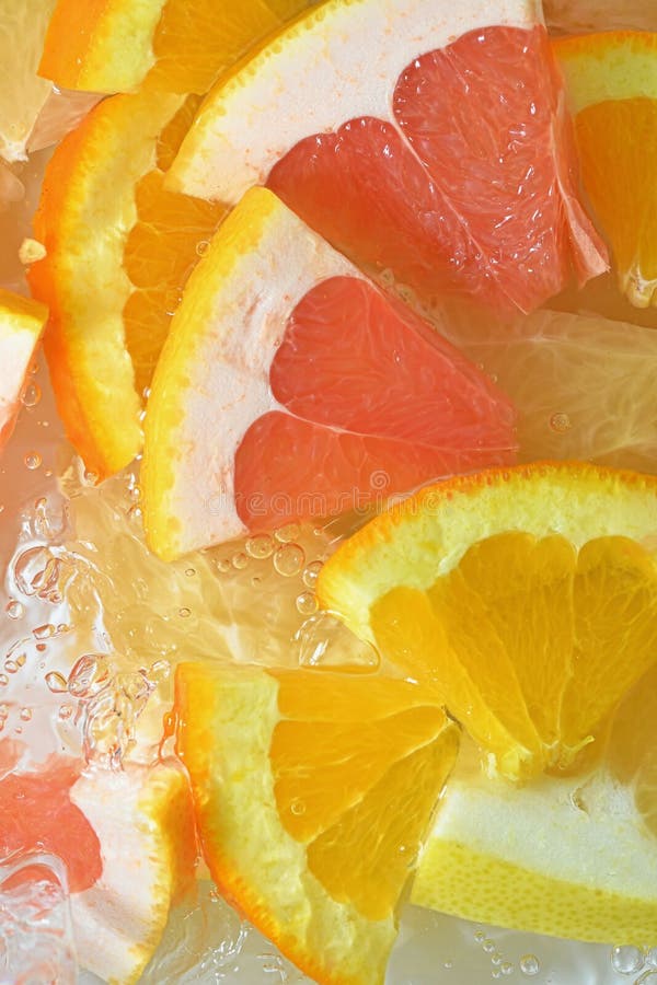 Slices of Grapefruit, Orange and Pomelo in Water on White Background ...