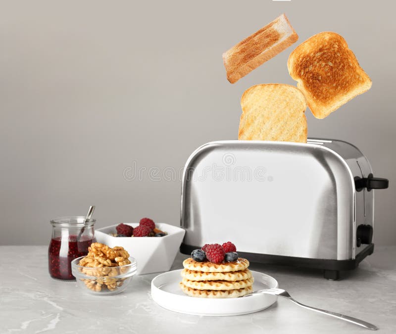 Slices of Grilled Wheat Bread Flying Out of Toaster on Marble Table ...