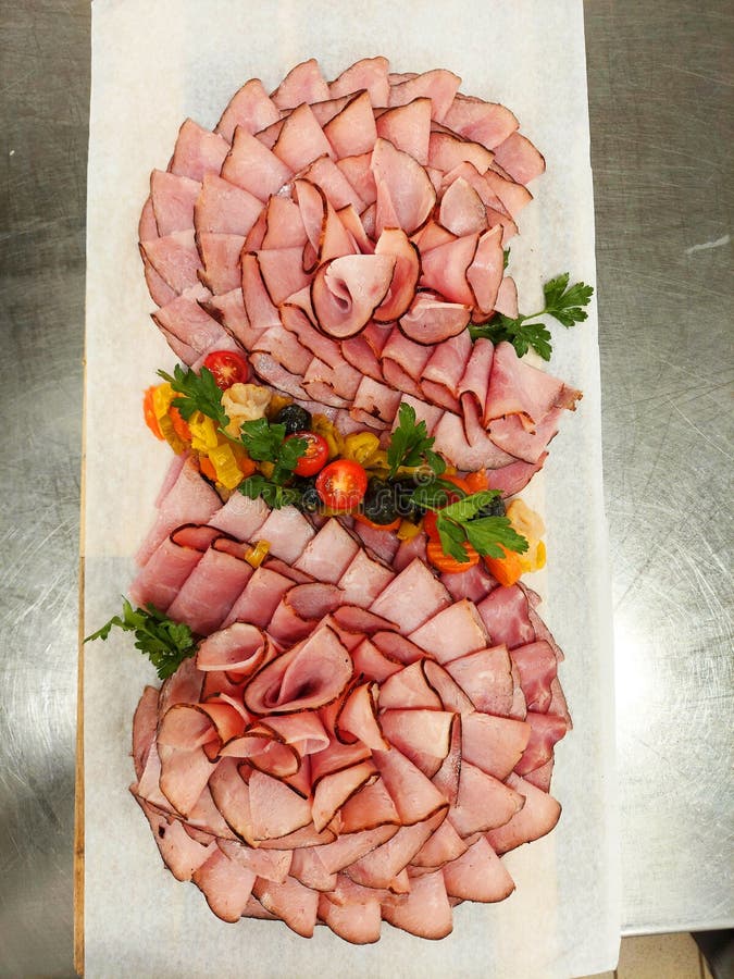 Slices of Ham Arranged on a Wooden Platter with Vegitables for Buffet ...