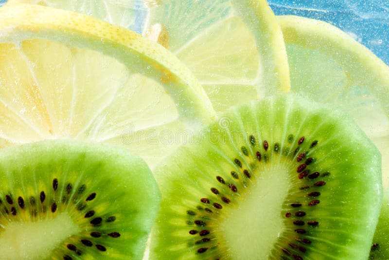 Slices of Kiwi and Lemon Float in Sparkling Bubbles, Creating ...