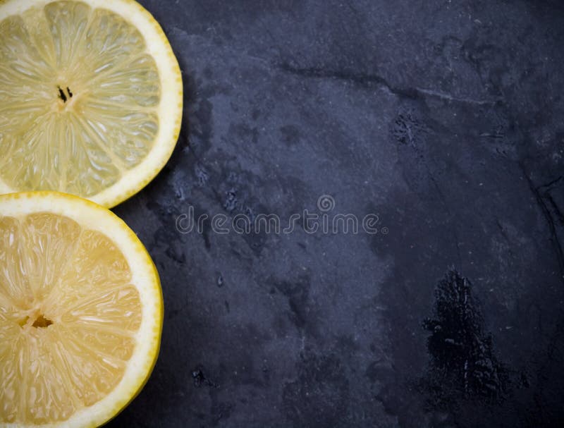 Slices of Lemon on Slate Wet Stone Stock Photo - Image of dark ...