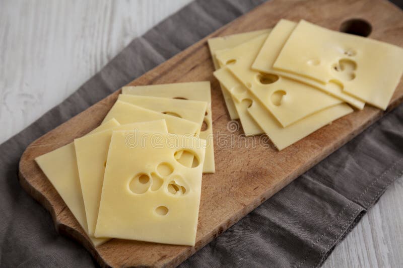 Slices of Maasdam Cheese on a Wooden Board, Side View Stock Image ...
