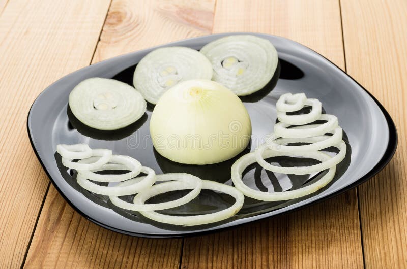 Slices of Onion in Black Plate on Table Stock Image - Image of onion ...