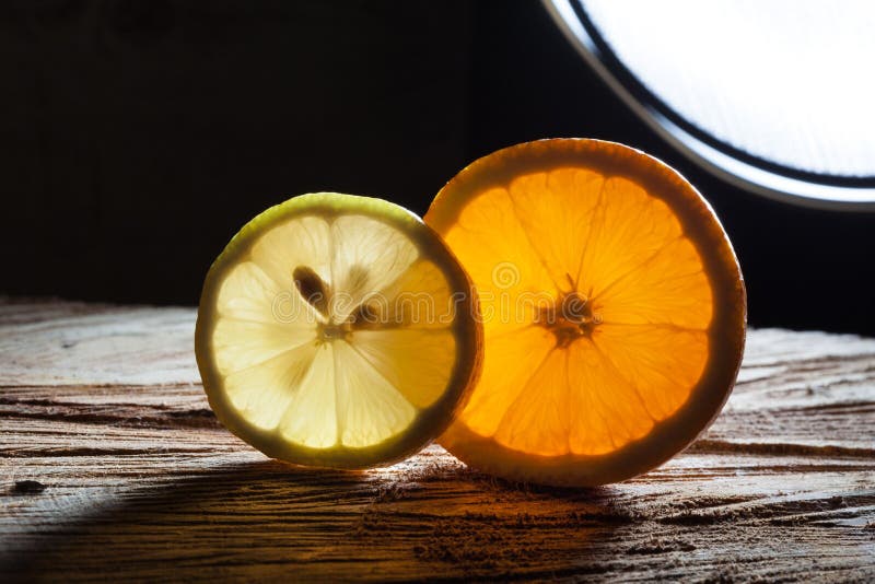 Slices Of Orange And Lemon On Rough Wooden Surface Stock Photo - Image ...