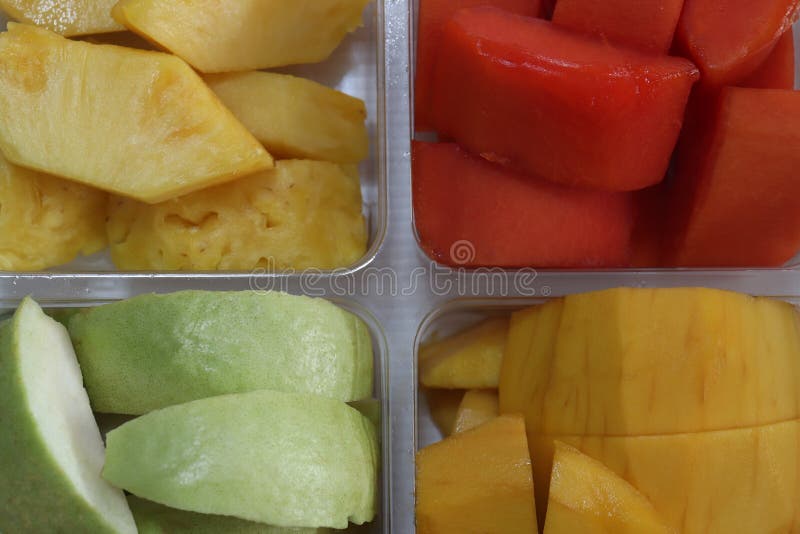 Slices of Pineapple, Papaya, Guava and Mango in a Clear Plastic Tray ...