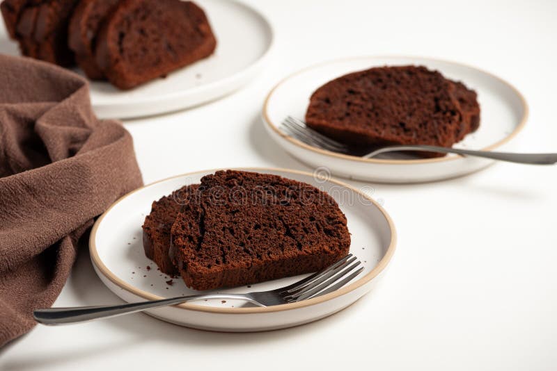 Slices of Rich Double Chocolate Pound Cake on White Plates. Front View ...