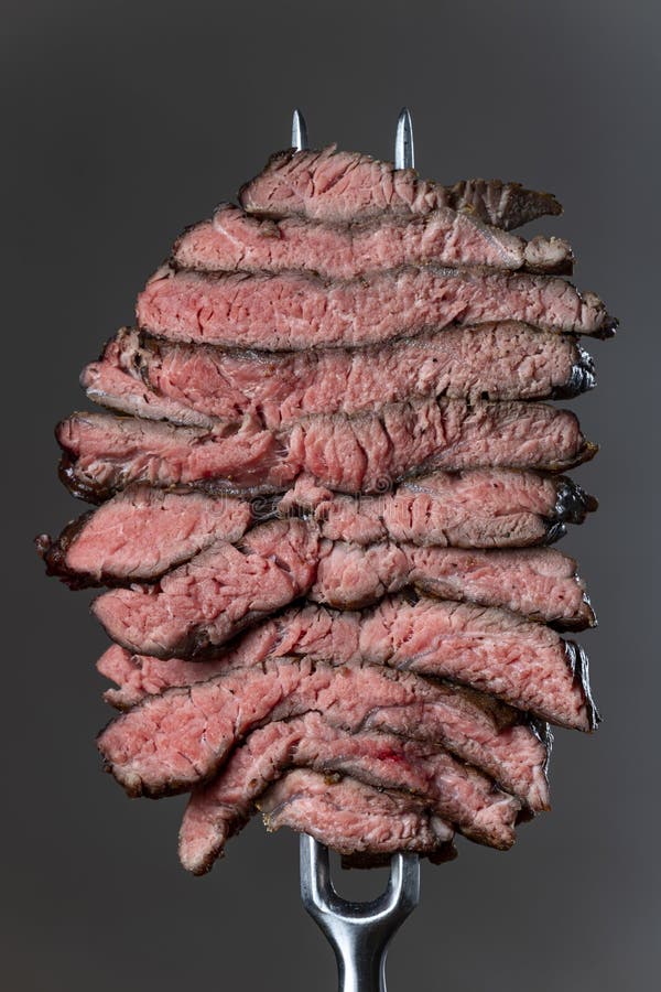 Slices of a steak on grey stock image. Image of fork - 168369699