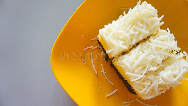 Slices of Steamed Cheese Cake on a Rectangular Orange Plate Stock Photo ...