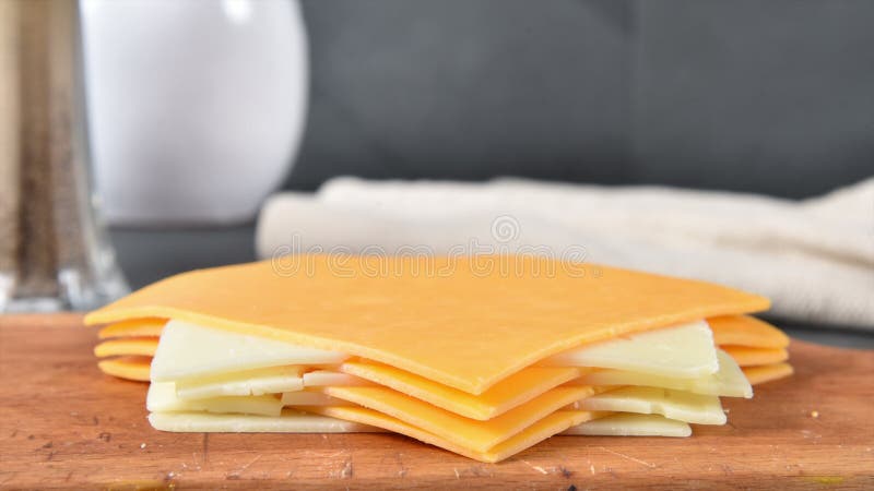 Slices of Swiss and Cheddar Cheese Vanishing from a Stack Stock Footage ... Slices of Swiss and Cheddar Cheese Vanishing from a Stack Stock Footage ...