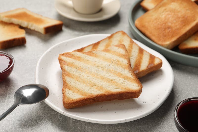 Slices of Tasty Toasted Bread and Jam on Light Grey Table Stock Image ...