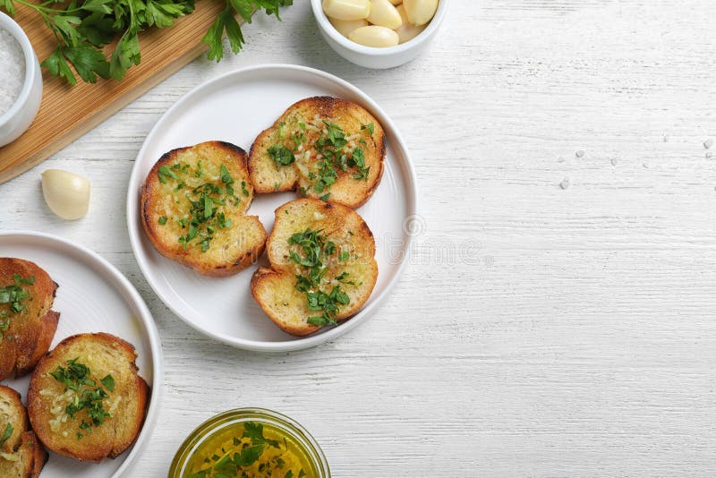 Slices of Toasted Bread with Garlic and Herb on White Table, Flat Lay ...