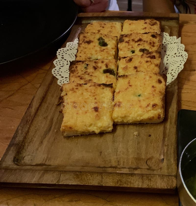 Slices Of Toasted Cheese Bread On Wooden Platter Stock Photo - Image of ...