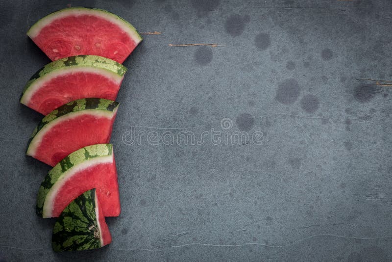 Slices of Watermelon on Left Side of Grey Background Stock Photo ...