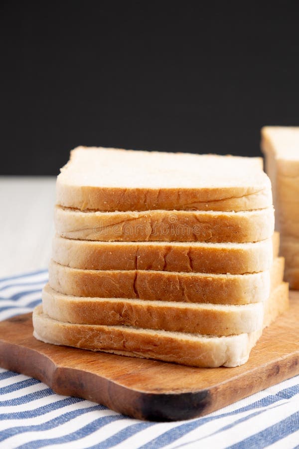 Slices of White Bread on a Rustic Wooden Board, Side View Stock Photo ...