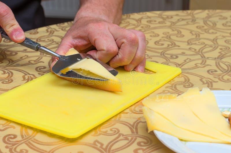 Slicing cheese Close-up stock photo. Image of yellow - 96820496