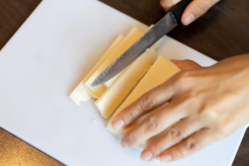 Slicing Cheese in the Kitchen Stock Photo - Image of craftsman ...