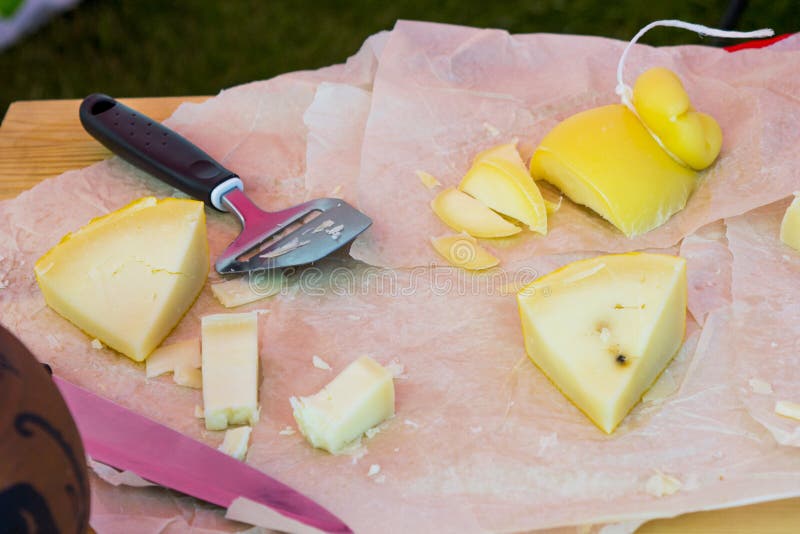 Slicing cheese for tasting stock image. Image of market - 95498575