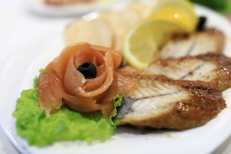Slicing fish on plate stock photo. Image of fish, lemon - 142752986