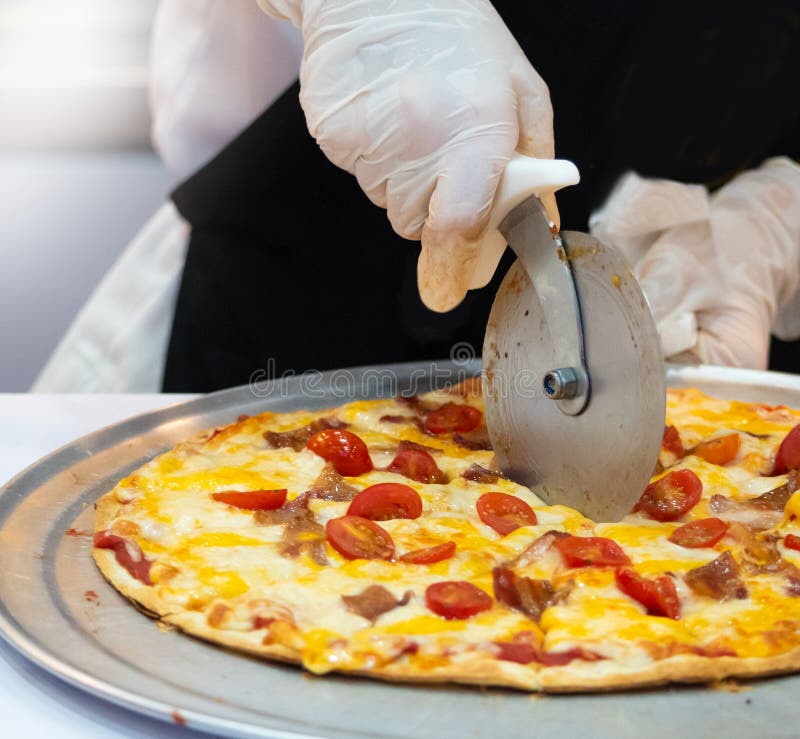 Slicing Fresh Made Italian Pizza, Closeup Hand of Chef Cutting Pizza in ...