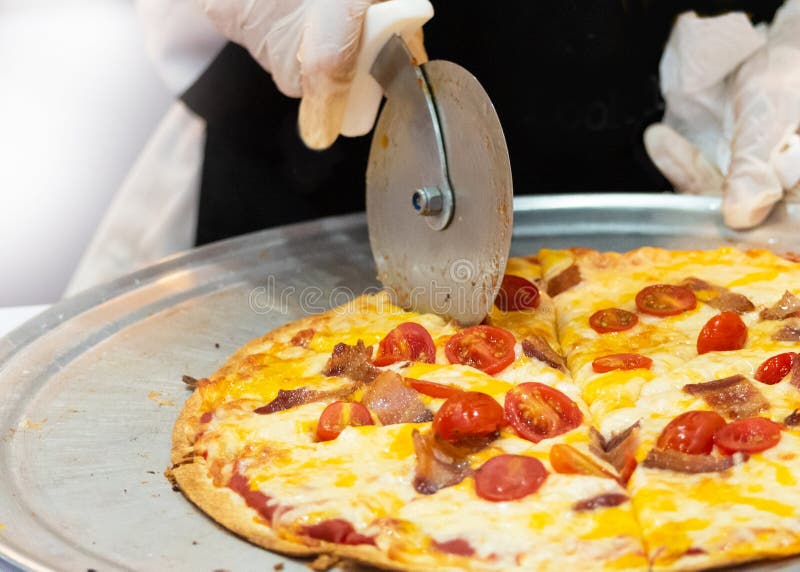 Slicing Fresh Made Italian Pizza, Closeup Hand of Chef Cutting Pizza in ...