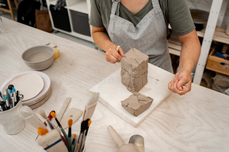 Slicing Off a Chunk of Clay from a Large Block Using a Sharp Wire Clay ...