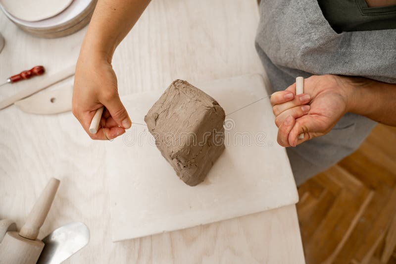 Slicing Off a Chunk of Clay from a Large Block Using a Sharp Wire Clay ...