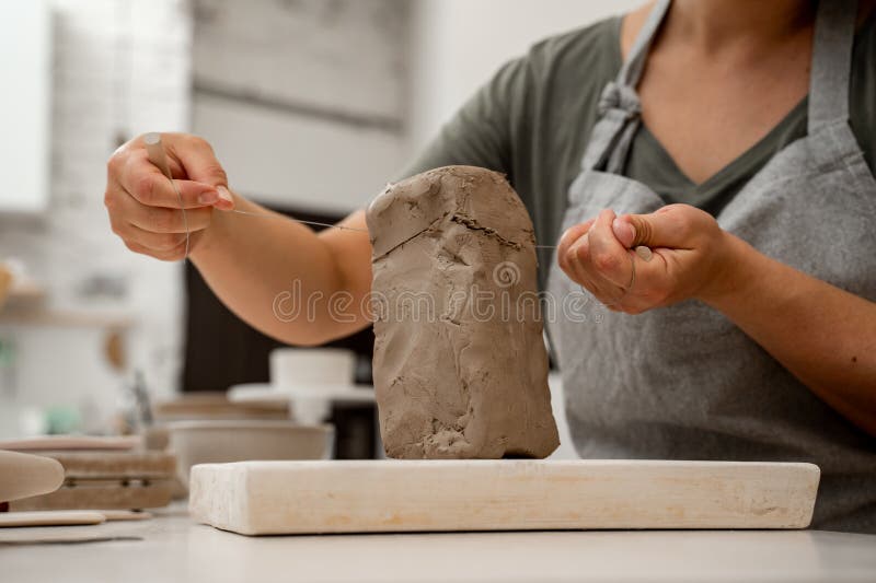 Slicing Off a Chunk of Clay from a Large Block Using a Sharp Wire Clay ...