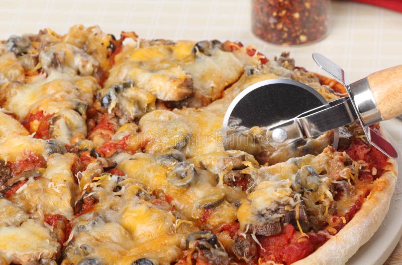 Slicing a Pizza stock photo. Image of meat, meal, mushroom - 29068838