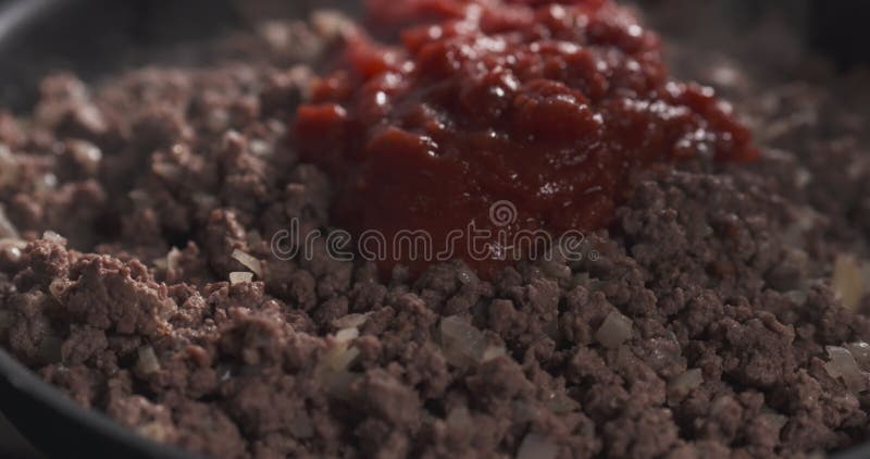 Slide Shot of Adding Tomato Paste into Roasting Minced Beef in a Pan ...