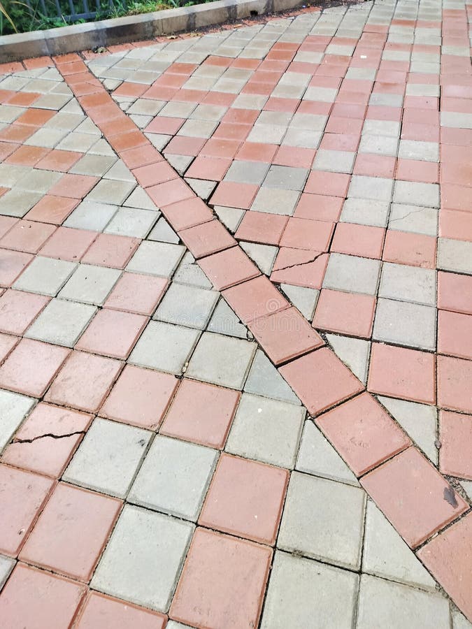 A Slightly Cracked Gray and Pink Paving Road that Needs Repair. Stock ...