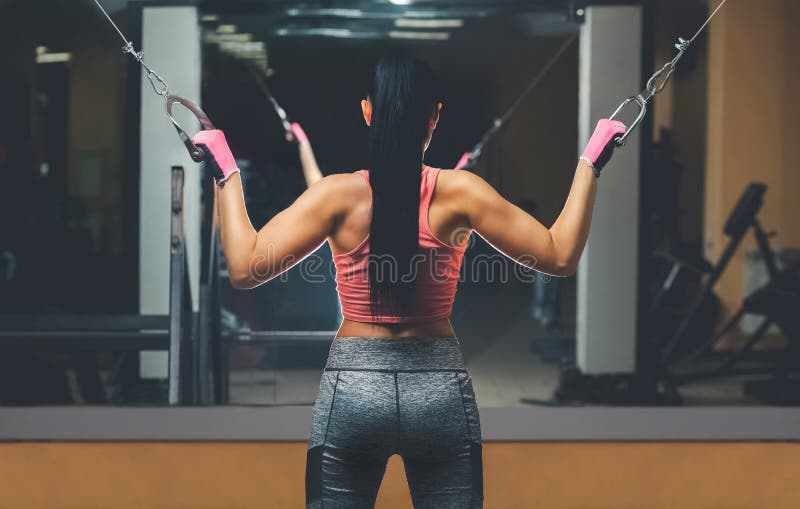 Slim, Bodybuilder Girl, Does the Exercises Standing in Front of Stock ...