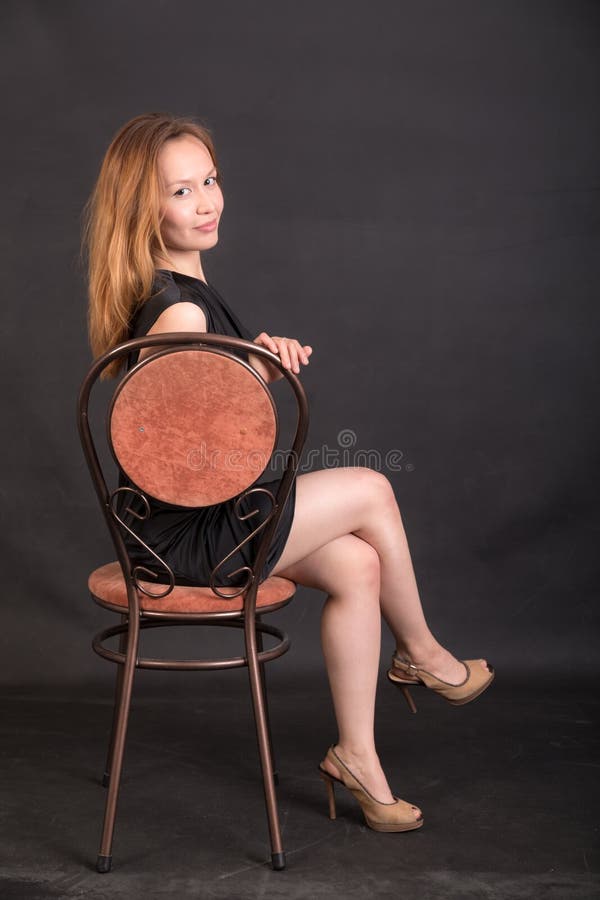 Slim girl on a chair stock image. Image of portrait - 261092455