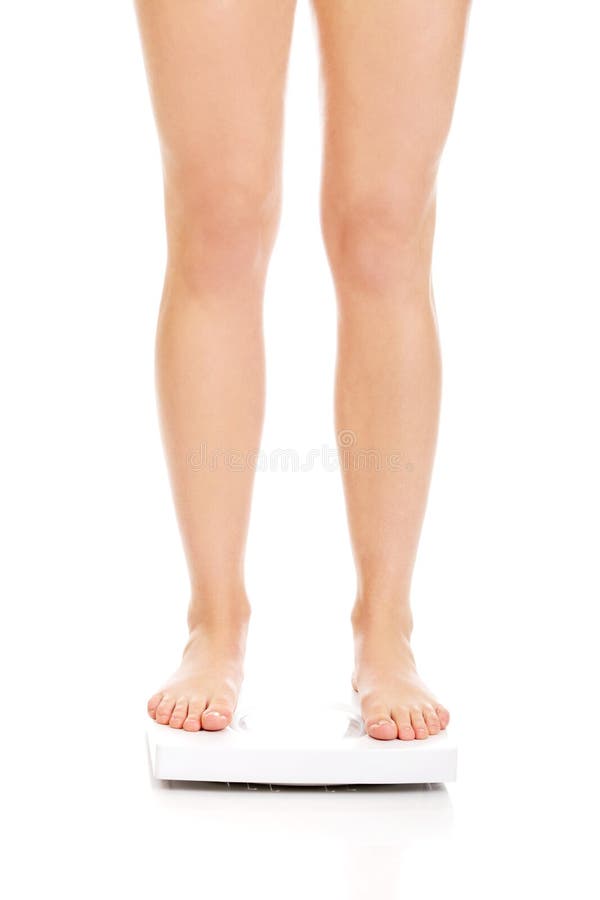 Slim woman s legs on scale stock photo. Image of control - 65189376