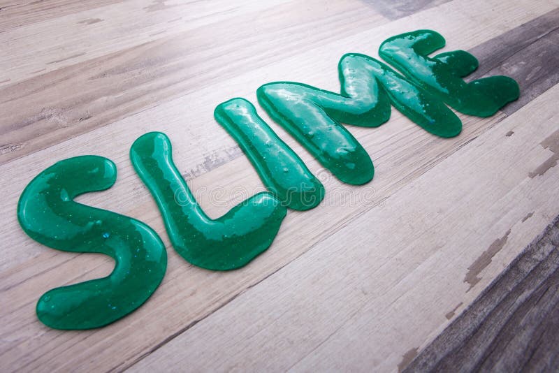 Slime Text Made from Transparent Slime Diagonally on a Wooden Surface ...