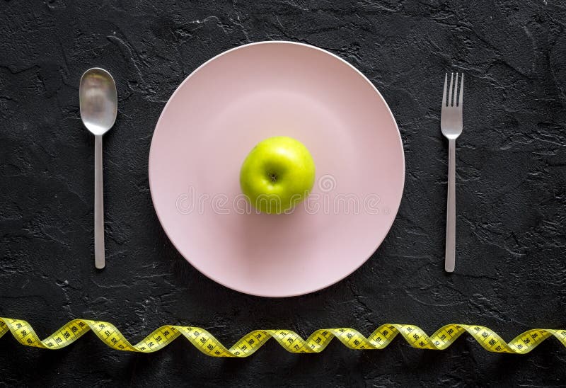 Slimming Diet. Apple at Plate and Measuring Tape on Black Background ...