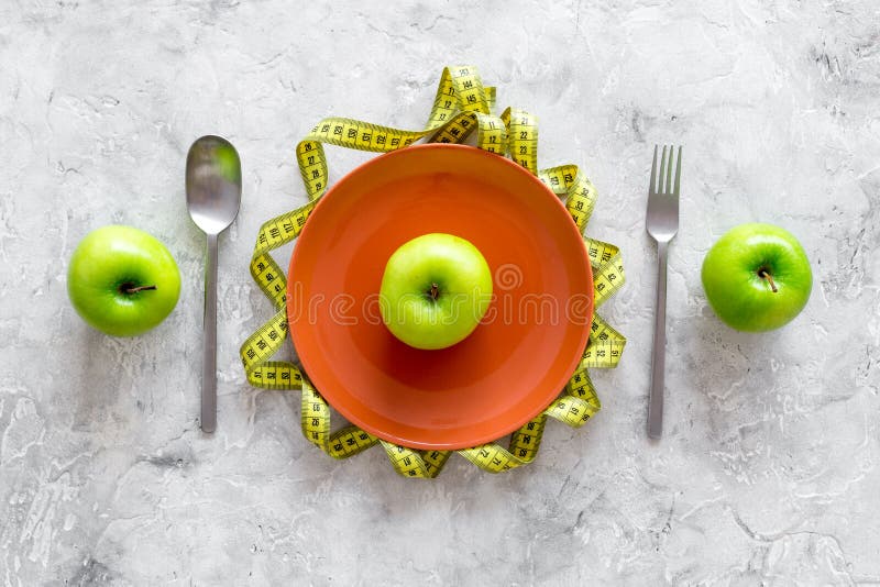 Slimming Diet. Apple at Plate and Measuring Tape on Grey Stone ...