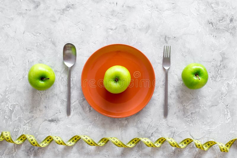 Slimming Diet. Apple at Plate and Measuring Tape on Grey Stone ...