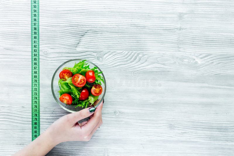 Slimming Diet. Salad and Measuring Tape on Grey Table Background Top ...