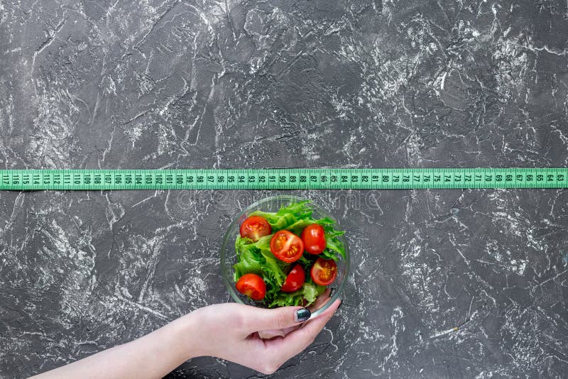 Slimming Diet. Salad and Measuring Tape on Grey Table Background Top ...