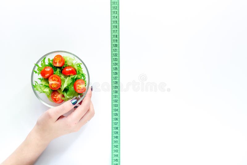 Slimming Diet. Salad and Measuring Tape on White Background Top View ...