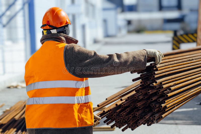 Slinger in Construction Helmet and Orange Vest Unloads Cargo on ...